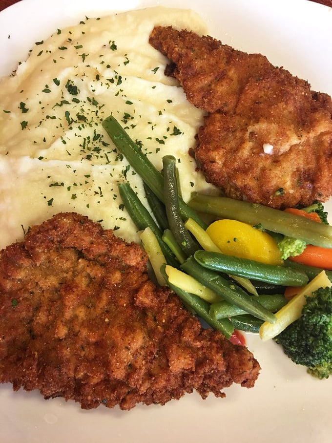 Golden-brown perfection! These schnitzel cutlets with mashed potatoes and vegetables are what comfort food dreams are made of.