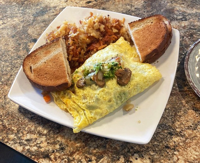 This veggie omelet doesn't just eat its vegetables – it celebrates them. Paired with crispy hash browns and toast, it's breakfast nirvana.