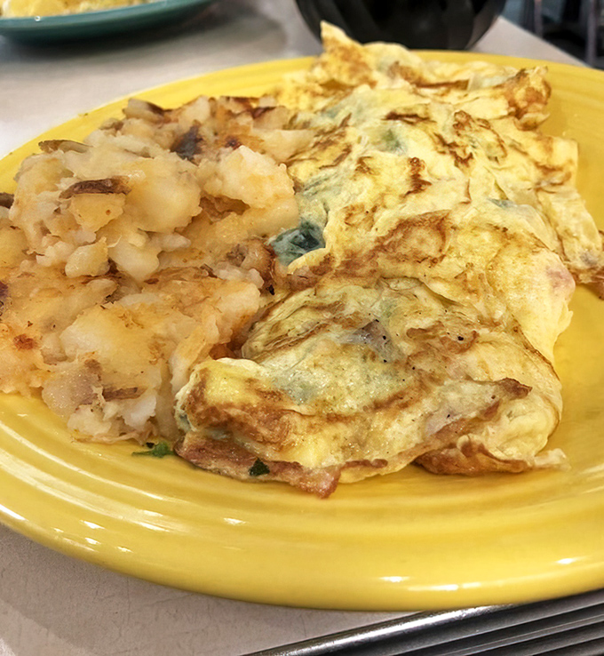 The perfect omelet doesn't exi&mdash;oh wait, here it is! Fluffy egg perfection alongside those legendary lyonnaise potatoes that steal the show.