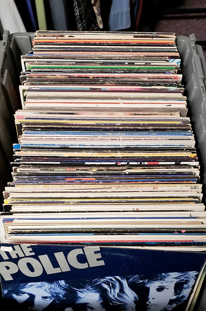 Vinyl treasures stacked like pancakes at a diner, with The Police on bottom offering the sweetest musical dessert for discerning collectors.
