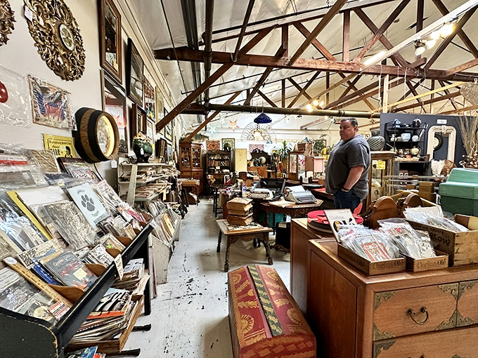 A browser contemplates his next discovery among shelves of vinyl records and vintage books&mdash;proof that one person's nostalgia is another's treasure hunt.