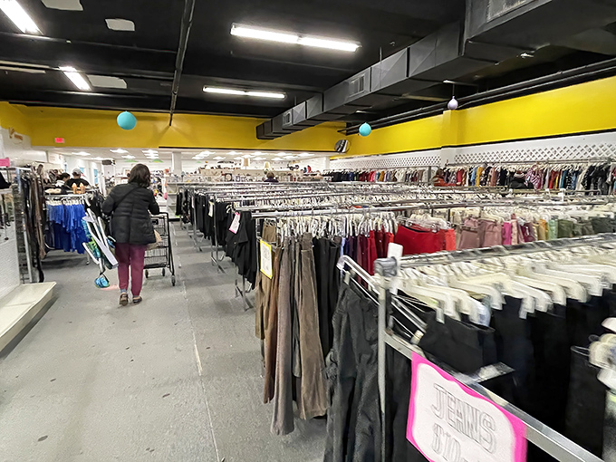 The yellow trim and organized racks create a surprisingly pleasant shopping experience, defying the chaos often associated with thrift stores.