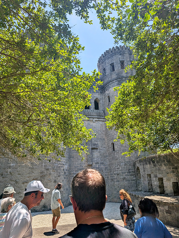 Visitors gather in the castle courtyard, momentarily transported from beach vacations to what feels like an impromptu medieval fair.