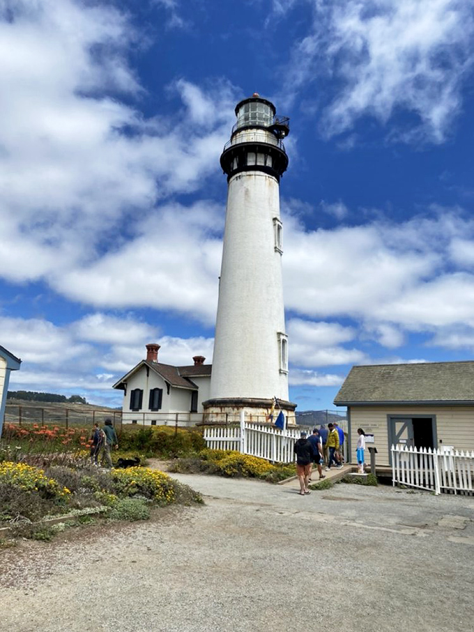 Visitors gather beneath the towering white column, looking appropriately tiny next to this 115-foot marvel of 19th-century engineering.