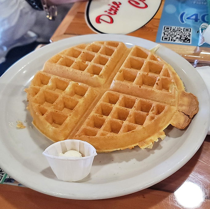 The Belgian waffle stands proud and golden, awaiting its maple destiny. Crisp exterior, fluffy interior &ndash; architecture that would make Frank Lloyd Wright weep with joy.