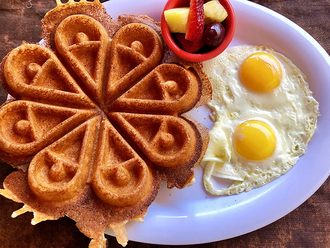 This isn't just any waffle &ndash; it's a flower-shaped masterpiece of crispy exterior and fluffy interior. Paired with perfect eggs, it's breakfast artistry.
