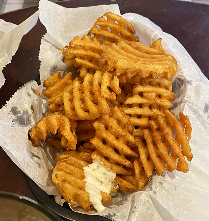 Not just any waffle fries &ndash; these golden, latticed beauties are seasoned to perfection, creating the ideal vehicle for house-made dipping sauces.