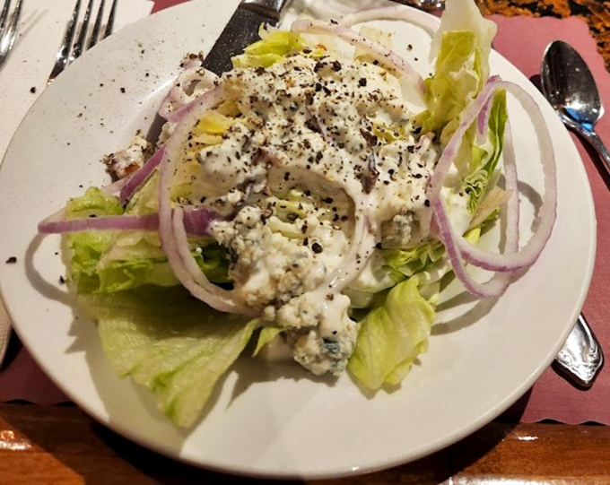 A wedge salad that means business&mdash;crisp iceberg lettuce, red onion rings, and blue cheese crumbles. The perfect opening act before the meaty main event.