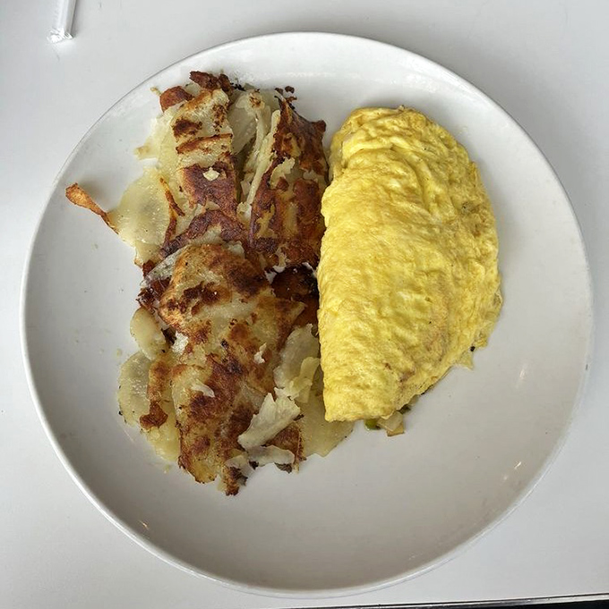 A perfect Western omelet meets hash browns in holy matrimony on this plate. Breakfast doesn't get more photogenic than this golden pair.