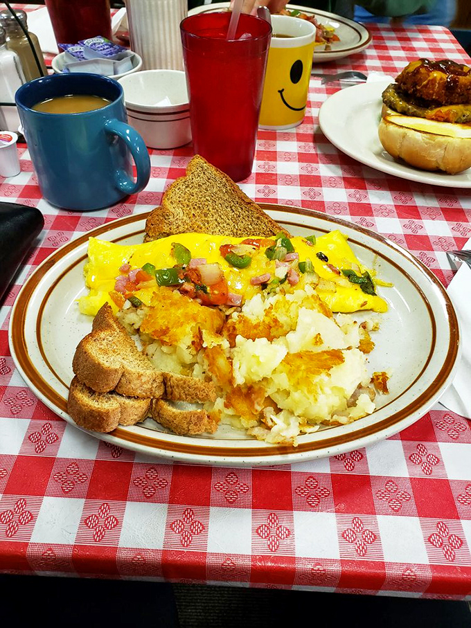 This isn't just an omelet&mdash;it's a masterpiece of morning engineering, with perfectly diced veggies and cheese melted just right. Toast stands ready for dipping duty.