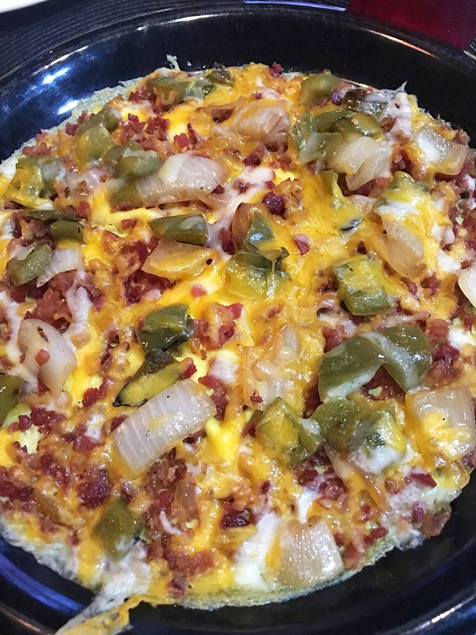 The Western omelet arrives looking like a cheese-covered landscape of morning delights. Those green peppers and onions aren't just toppings&mdash;they're flavor ambassadors.