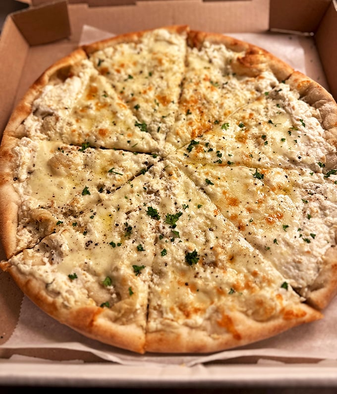 White pizza that proves sometimes the best things in life skip the red sauce. This cheese-forward masterpiece would make any Italian grandmother nod approvingly.