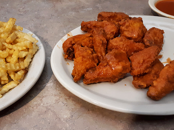 These aren't just wings; they're crispy, golden-brown messengers of joy that make you wonder why anyone bothers with fancy food when perfection is this simple.