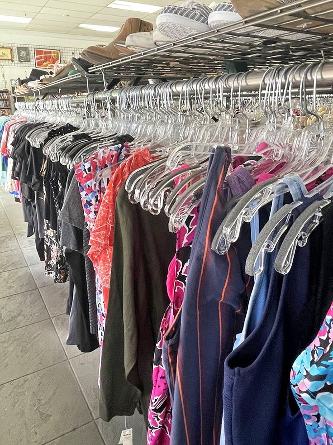 The rainbow of possibilities hanging neatly in rows—where your next favorite outfit is hiding between patterns from decades past.