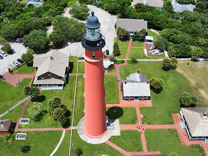 From above, the lighthouse compound reveals itself as a perfectly preserved slice of maritime history, with the keeper's house nestled at its base.