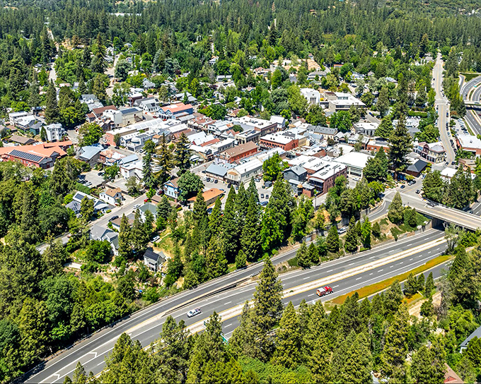 From above, Nevada City reveals itself as a perfect circle of civilization carved into the endless emerald forest of the Sierra foothills.