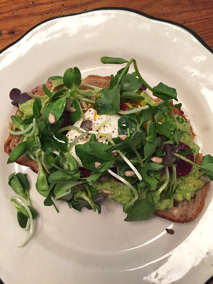 Avocado toast that makes millennials' housing decisions seem justified &ndash; a verdant landscape of green goodness topped with what appears to be a perfectly poached egg.