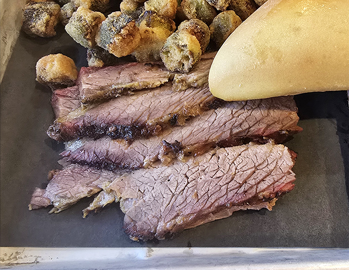 Brisket sliced so perfectly it could make a Texan weep with joy. The smoke ring is practically a halo.
