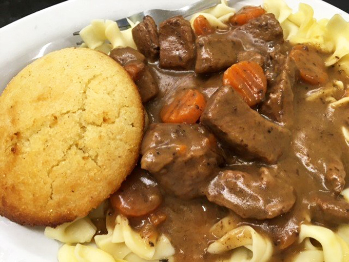 Beef tips and gravy over noodles with a perfect cornbread sidekick. This plate doesn't just feed your body&mdash;it hugs your soul and whispers, "Everything's gonna be alright."