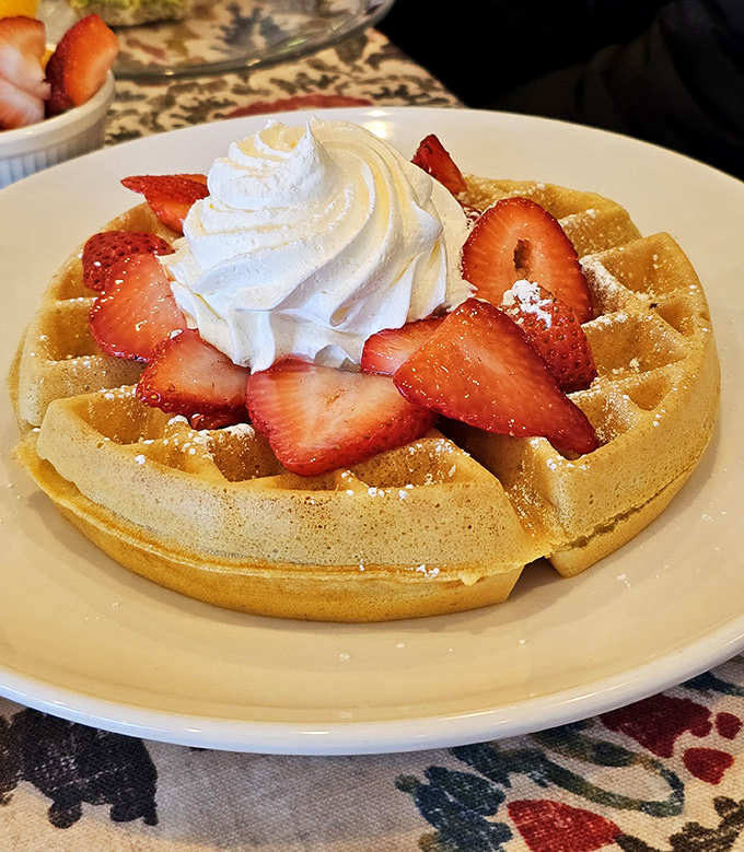 A Belgian waffle topped with fresh strawberries and whipped cream&mdash;proof that sometimes the classics don't need reinventing, just perfecting.