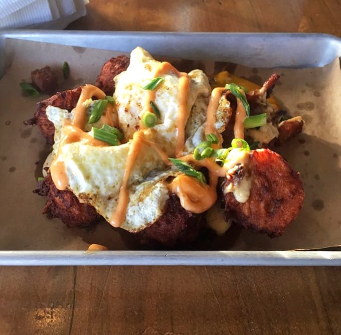 Braised pork tots topped with enough goodness to make your cardiologist nervous but your taste buds ecstatic.