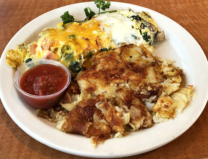 This omelet and hash brown combo isn't trying to reinvent the wheel—it's just making that wheel absolutely perfect. Crispy meets fluffy in breakfast harmony.