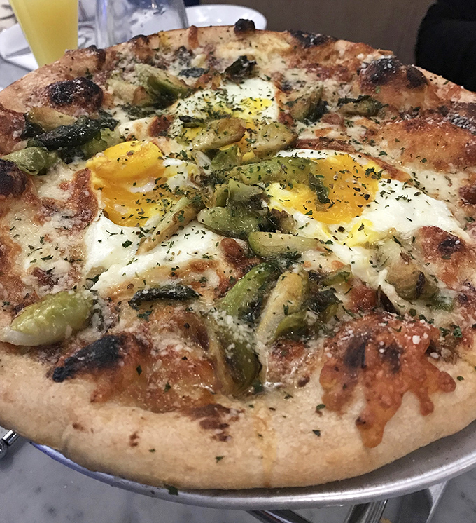 Breakfast pizza that answers the eternal question: "Why can't I have eggs on everything?" Those sunny yolks are nature's perfect sauce.