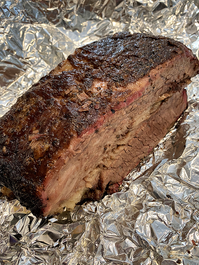 Brisket so perfectly rendered it should be hanging in the Louvre. The smoke ring is practically hypnotic.