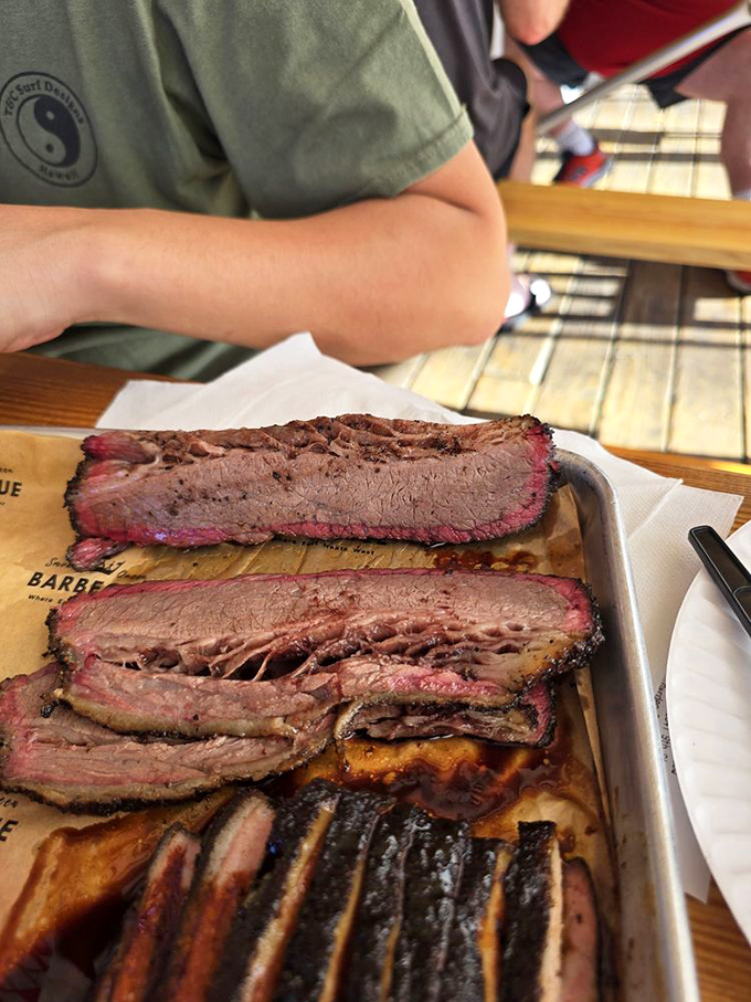Behold the holy grail of barbecue: perfectly smoked brisket with that coveted pink ring. Meat this good needs no introduction.