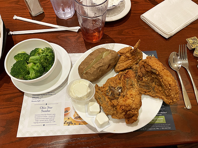 Broasted chicken so perfectly golden, it deserves its own trophy. Paired with a baked potato and broccoli for the illusion of balance.