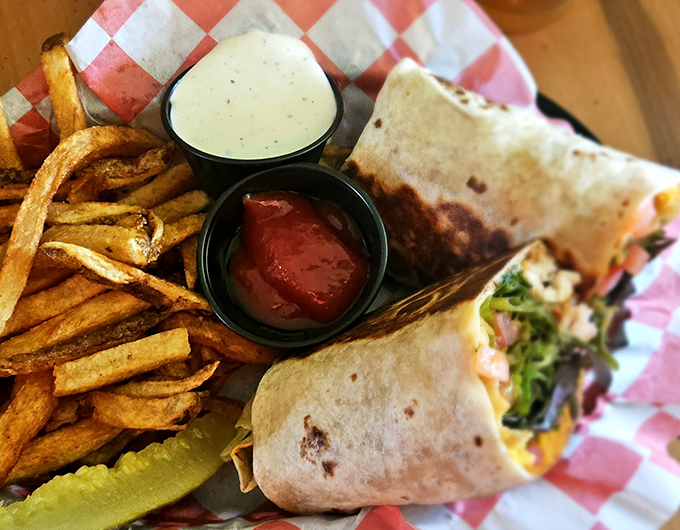 This isn't your sad desk lunch wrap. Golden fries, house-made dipping sauces, and a wrap stuffed fuller than my suitcase after vacation.