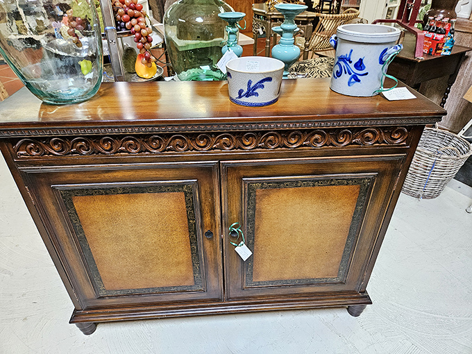 This ornately carved cabinet whispers tales of craftsmanship from an era when furniture wasn't assembled, but lovingly created.