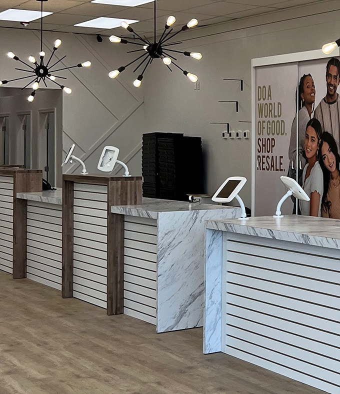 The checkout area looks more like a high-end boutique than a thrift store. Those sputnik chandeliers mean business!