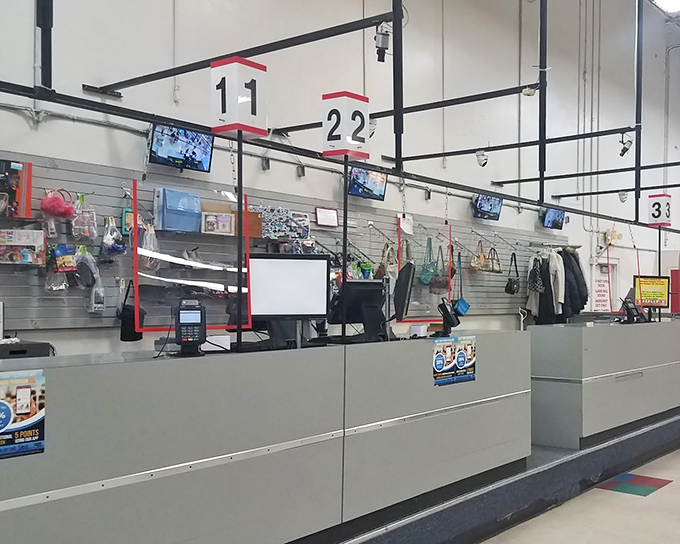 Checkout stations numbered like game shows, where the prize isn't what you bought but how little you spent.