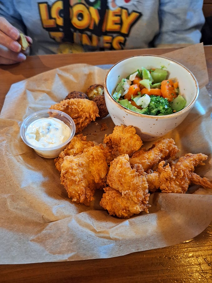 Golden-fried treasures nestled alongside vibrant vegetables&mdash;proof that sometimes the best things in life come in paper-lined baskets.