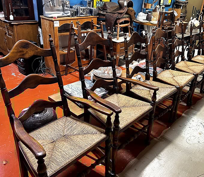 A lineup of ladder-back chairs standing at attention like wooden soldiers. Each woven seat has cradled generations of family dinners and lively conversations.