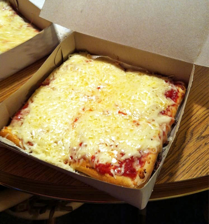 The rectangular cheese pizza comes in a simple white box&mdash;no fancy packaging needed when what's inside is this good.