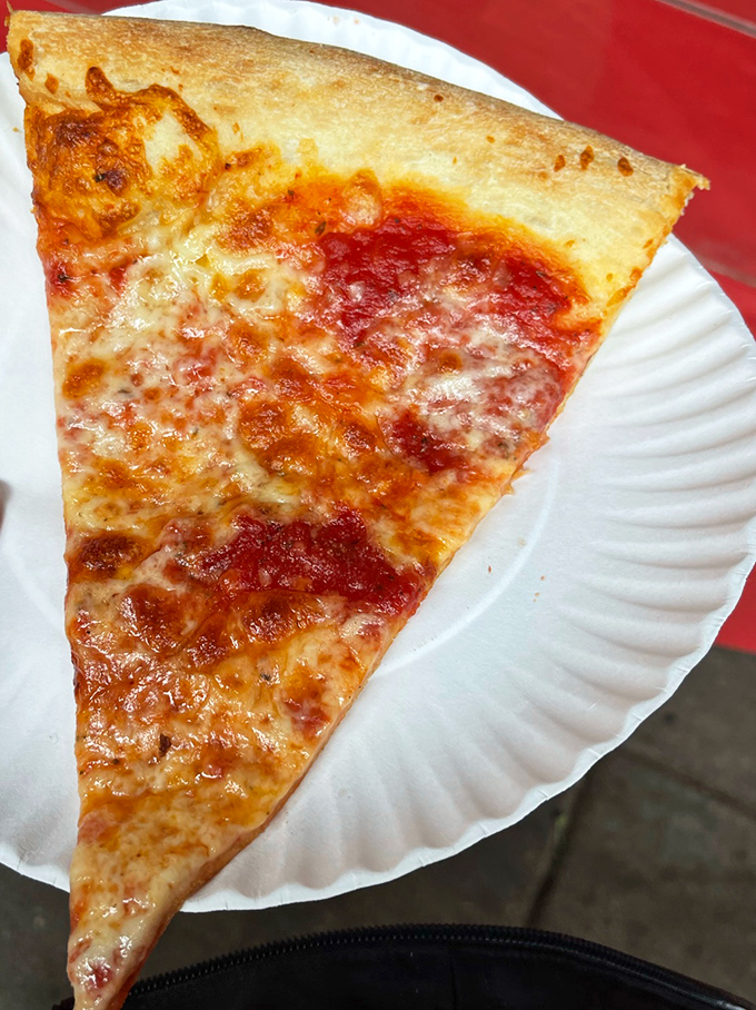 The classic cheese slice at Lorenzo's—where size matters and folding is not optional but necessary life skill.