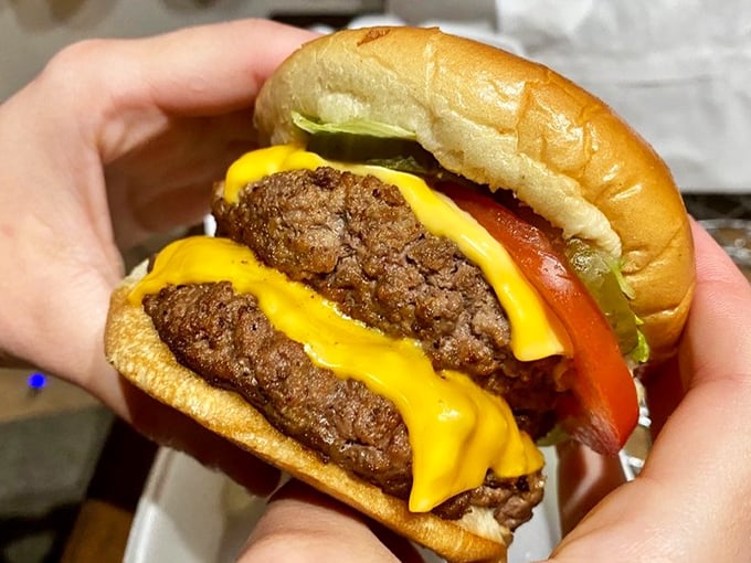This isn't just a cheeseburger; it's edible architecture &ndash; a perfect stack of beef, cheese, and fresh veggies on a pillowy bun.