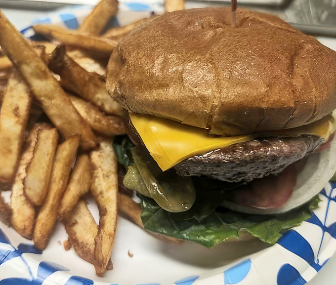 Behold the humble cheeseburger in its natural habitat&mdash;juicy, perfectly melted cheese, and those hand-cut fries that somehow taste better in places with wood paneling.