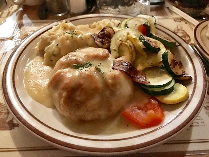 Comfort on a plate: A golden-brown chicken pot pie surrounded by seasonal vegetables that would make any grandmother nod in approval.