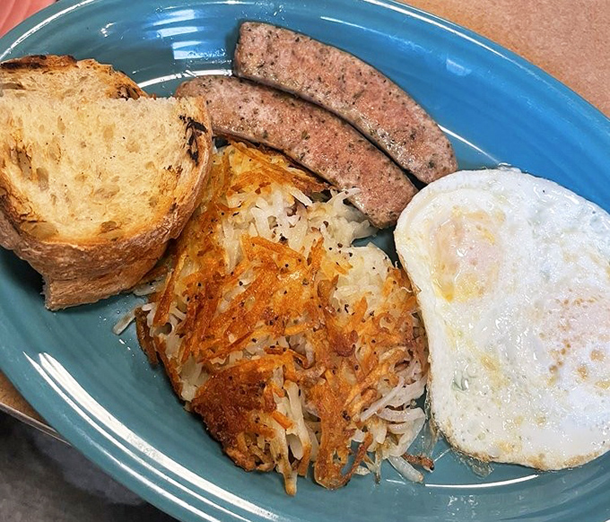 This isn't just breakfast&mdash;it's a perfectly choreographed dance of crispy hash browns, savory sausage, and a sunny-side egg waiting for its standing ovation.