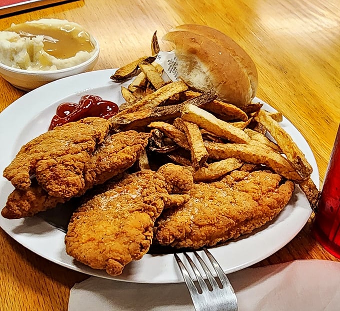 Golden-fried chicken tenders that would make the Colonel salute in respect. Crispy outside, juicy inside—proof that simple food done right is culinary poetry.