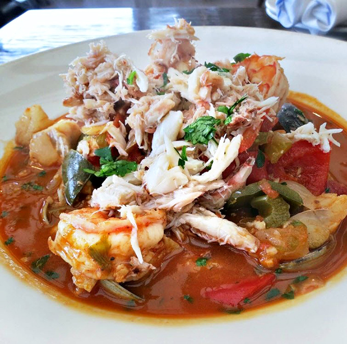 Cioppino that would make Italian fishermen weep with joy. A tomato-based symphony where crab, shrimp, and fish harmonize in seafood perfection.