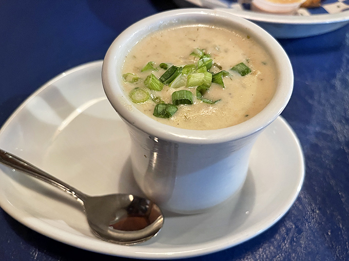 The clam chowder arrives like a warm hug in a bowl, creamy and flecked with green onions that add both color and a gentle bite.