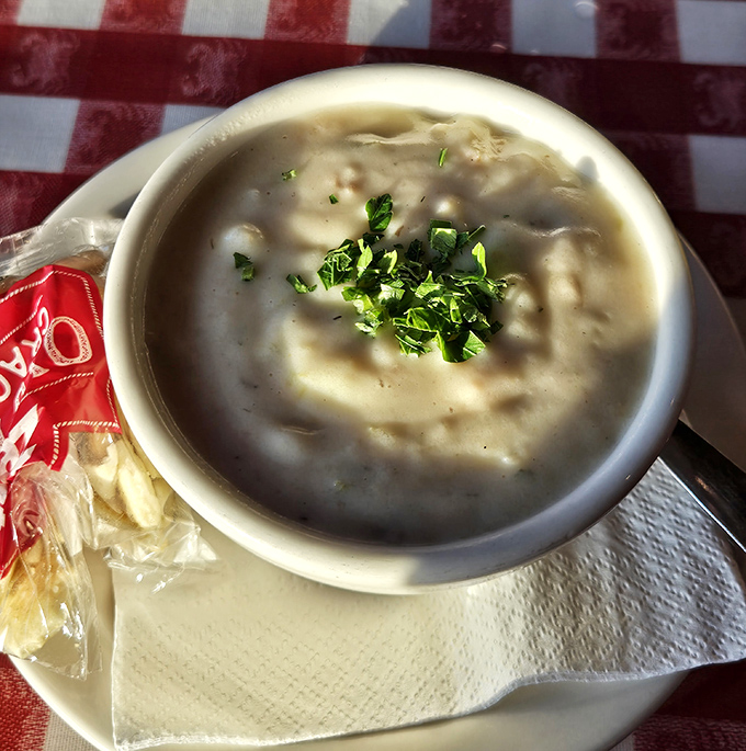 Clam chowder so creamy and comforting, it could end family feuds. That sprinkle of fresh herbs is like the perfect punchline to a delicious joke.