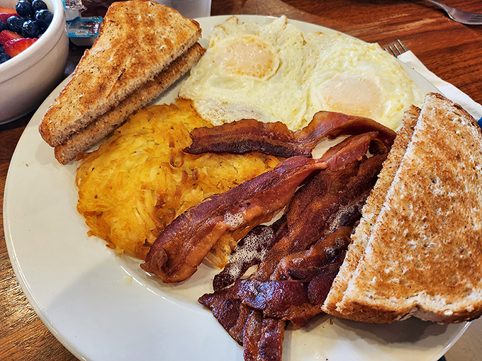 The classic breakfast plate&mdash;where eggs, bacon, and toast perform their timeless morning symphony. Comfort food that speaks a universal language.