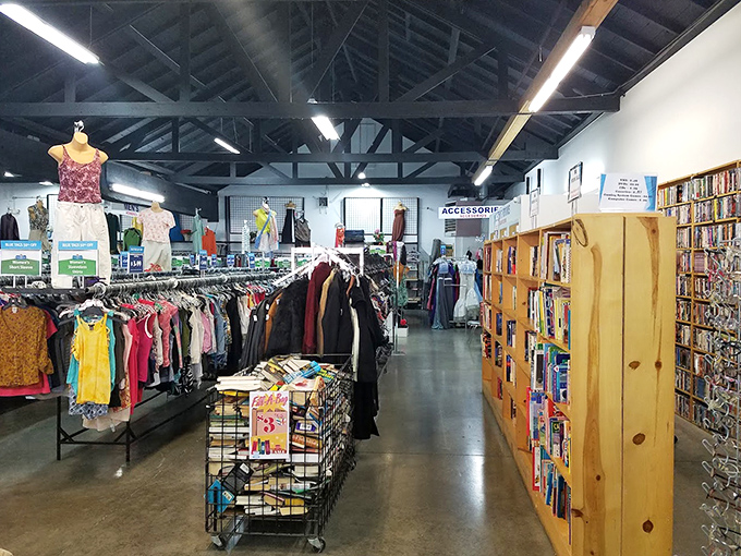 The clothing racks neighbor an impressive book collection &ndash; outfit your body and mind in one strategic shopping trip.