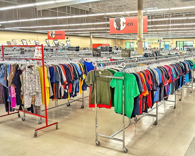 The clothing section stretches toward retail infinity. Like a rainbow organized by helpful elves, every hue and style awaits its second chance at fashion glory.