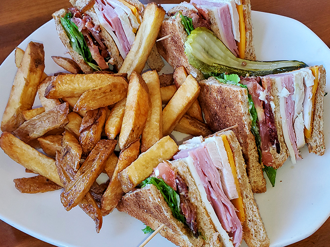 This club sandwich isn't just stacked&mdash;it's architectural genius with layers of ham, turkey, and bacon creating the skyscraper of sandwich satisfaction.